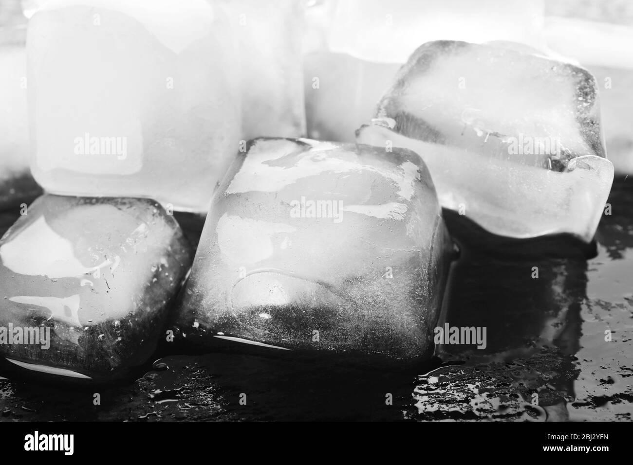 Matted ice cubes on dark liquid background Stock Photo - Alamy