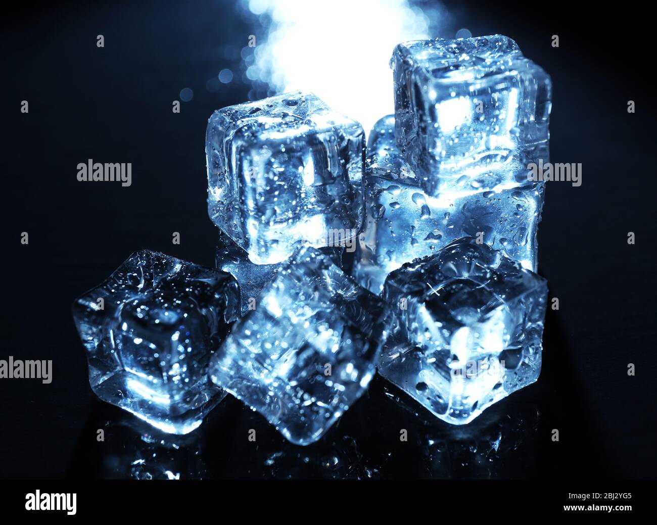 Shining ice cubes under blue light on liquid background Stock Photo - Alamy