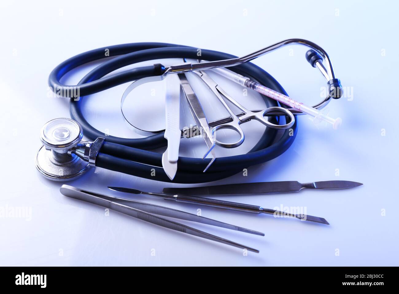 Stethoscope and surgery instruments on white background, close up Stock ...
