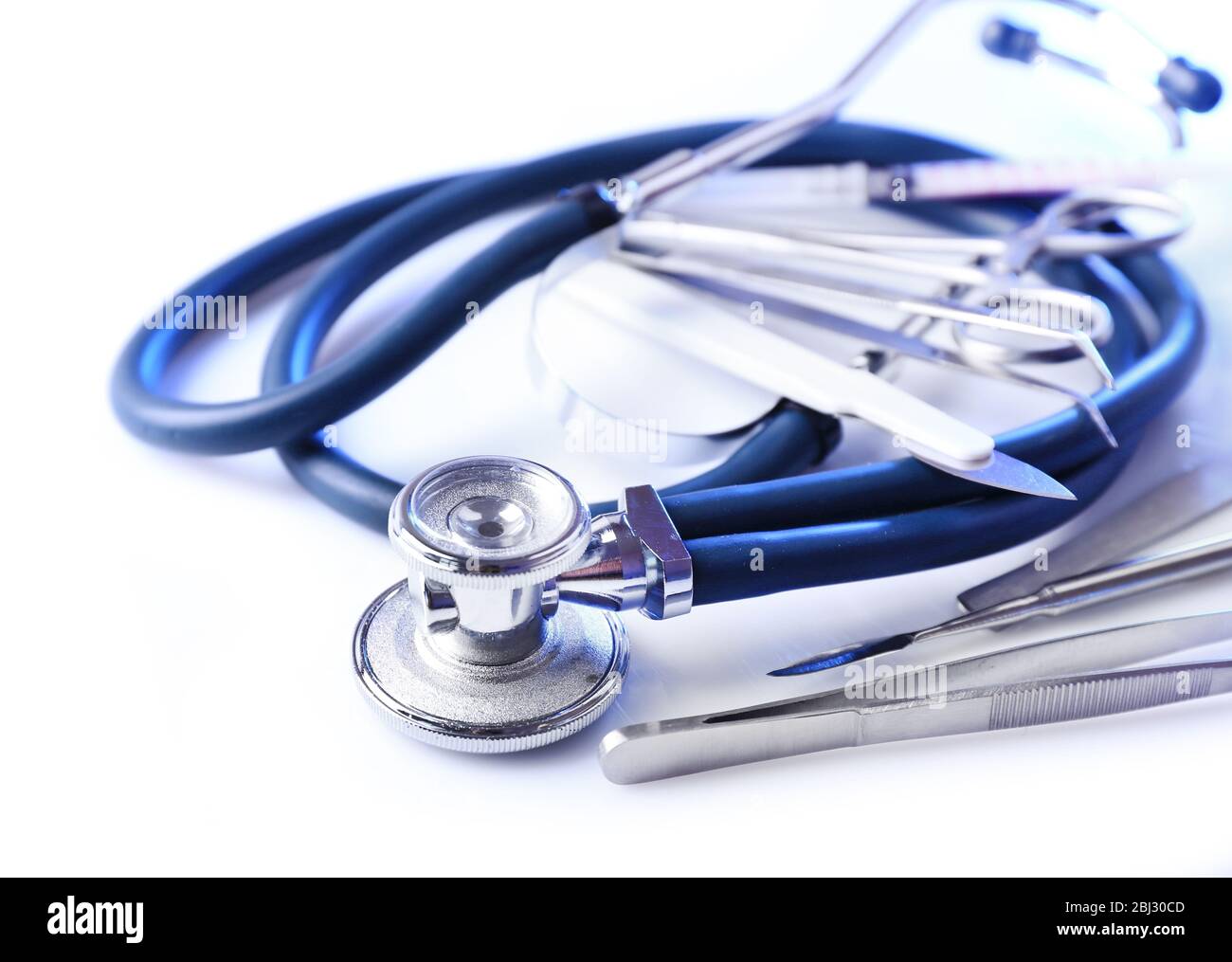 Stethoscope and surgery instruments on white background, close up Stock ...