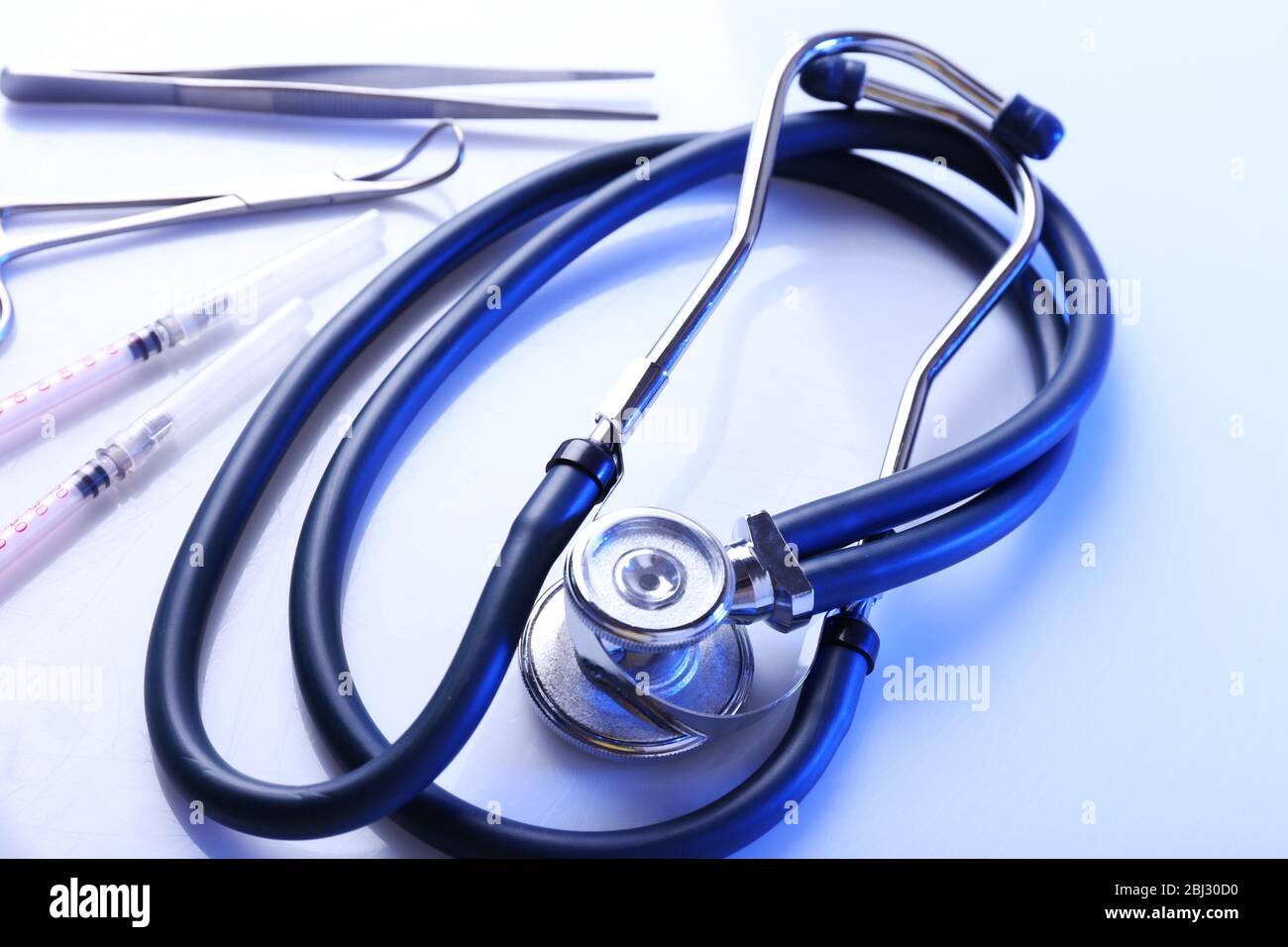 Stethoscope and surgery instruments on white background, close up Stock ...
