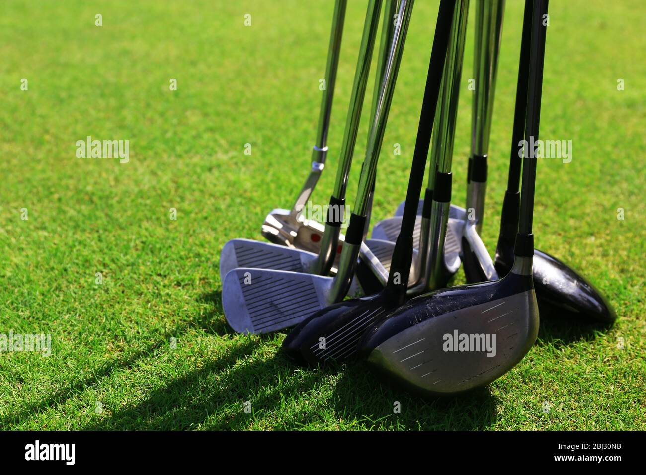 Different expensive golf clubs on green luxury golf course Stock Photo ...