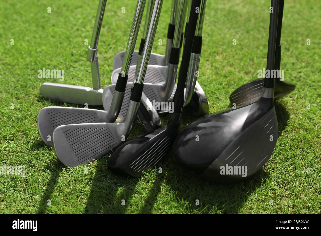 Different expensive golf clubs on green luxury golf course Stock Photo ...