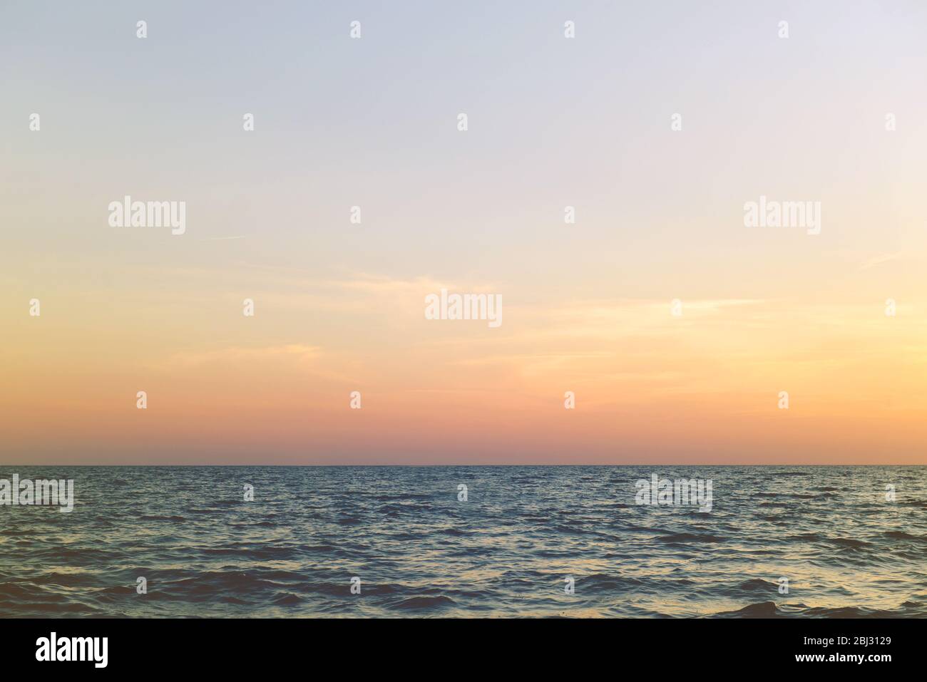 Sunset on the summer beach Stock Photo - Alamy