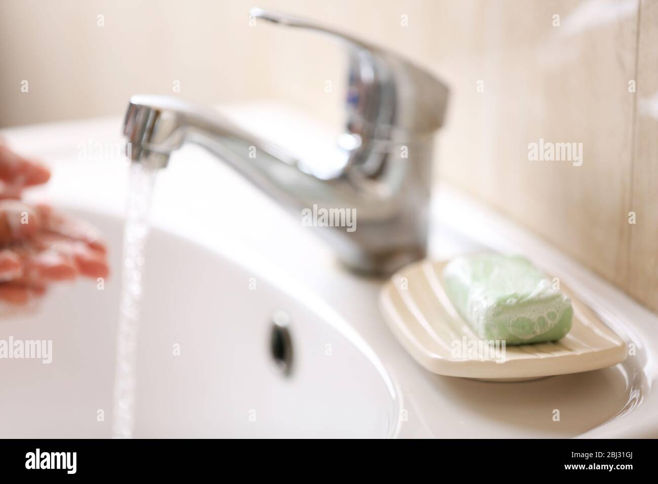 Washing of hands with soap under running water Stock Photo - Alamy