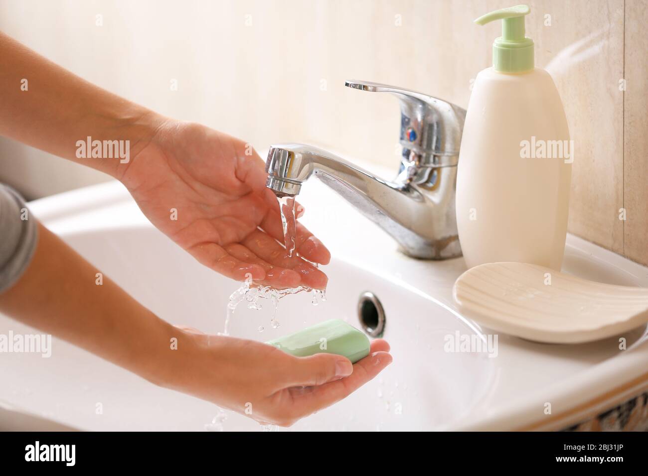 Washing of hands with soap under running water Stock Photo - Alamy