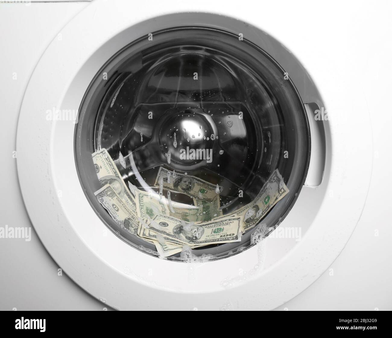 Laundering of dirty money in washing machine, close up Stock Photo - Alamy