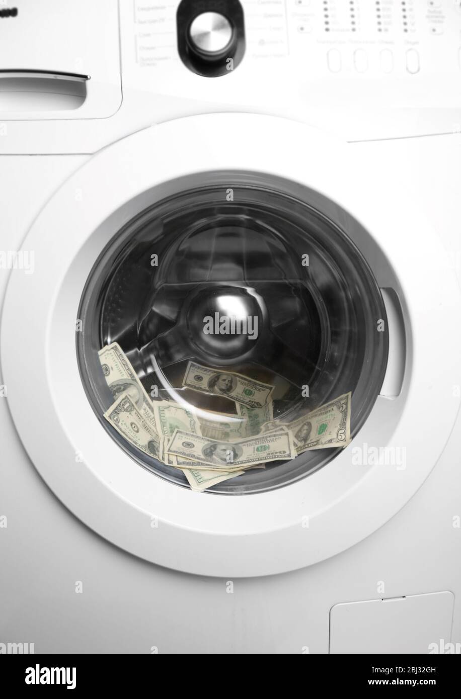 Laundering of dirty money in washing machine, close up Stock Photo - Alamy