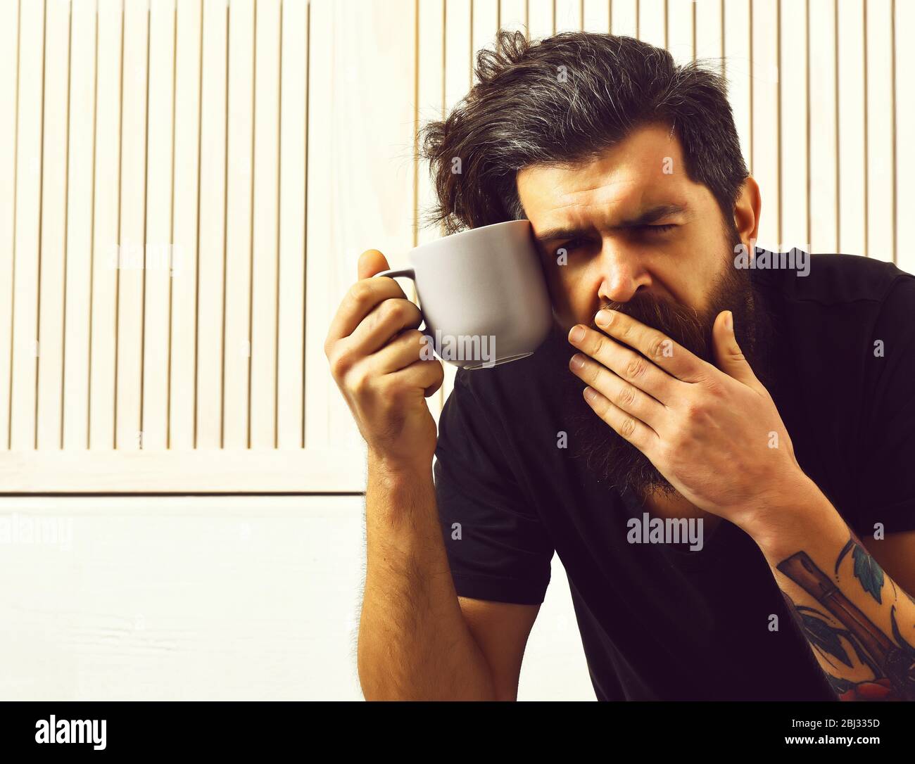 Bearded man, long beard. Brutal tattooed yawning caucasian hipster with ...