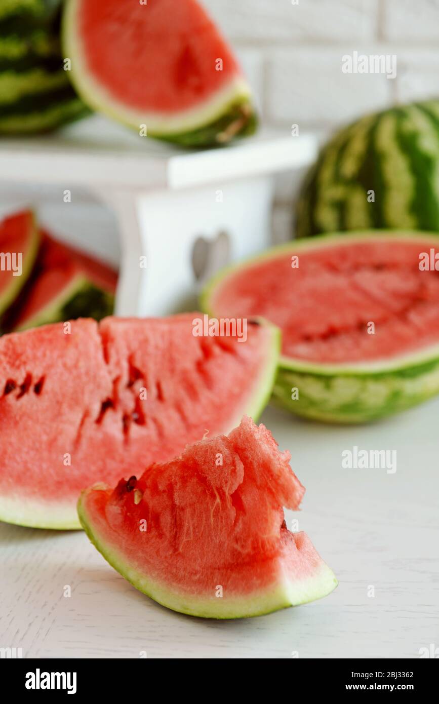 Sliced watermelons on brick wall background Stock Photo - Alamy