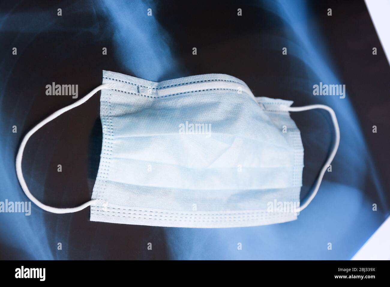 Blue respiratory mask on x-ray of human lungs, Close up. Coronavirus ...