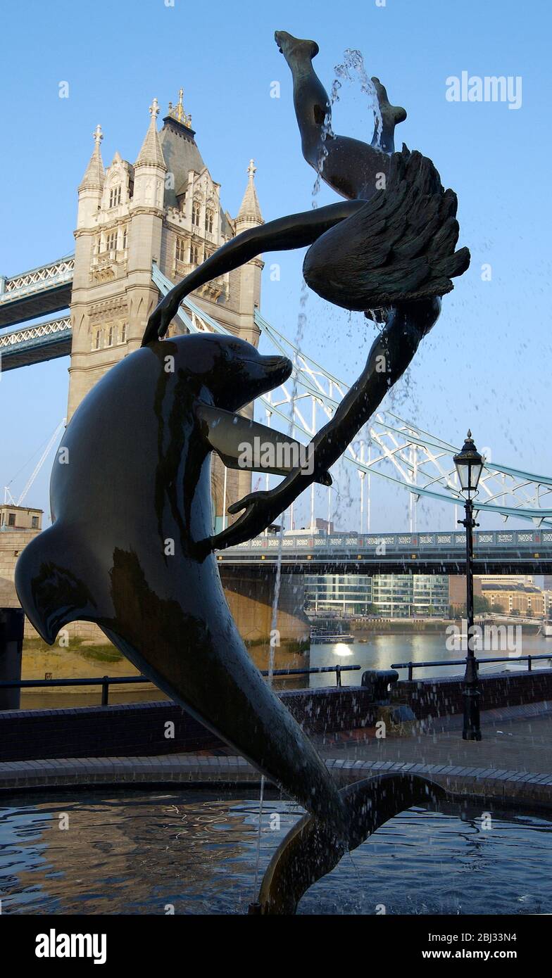 Girl with a Dolphin Fountain with a backdrop of the iconic Tower Bridge ...