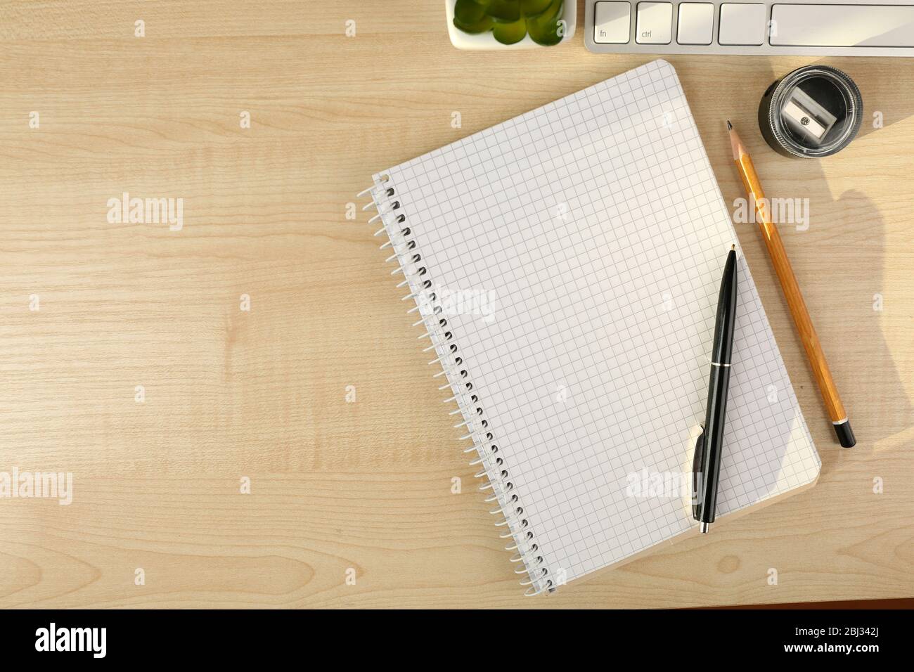 White keyboard and notebook on the desk Stock Photo - Alamy