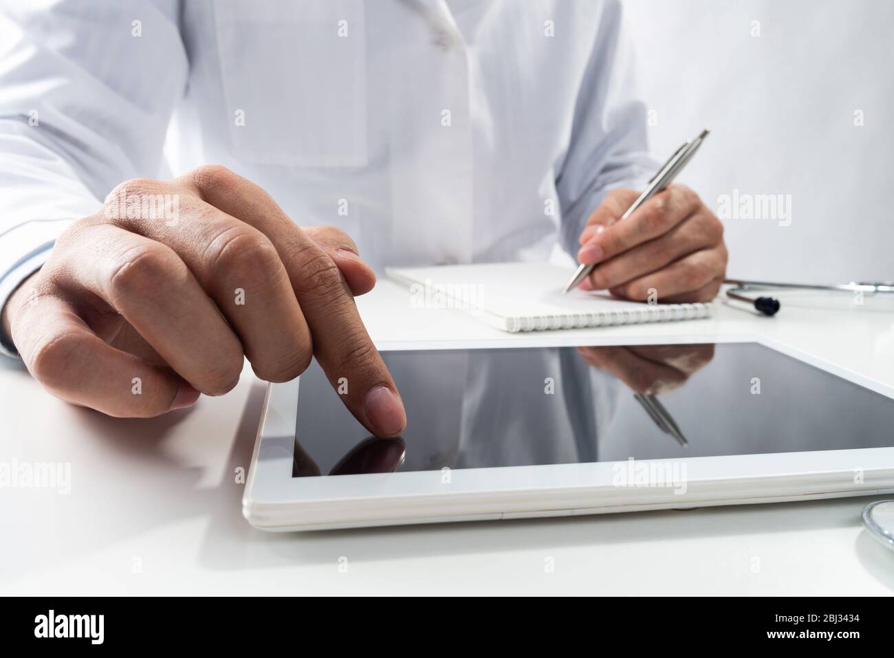 Close up of therapist hands using tablet computer Stock Photo - Alamy