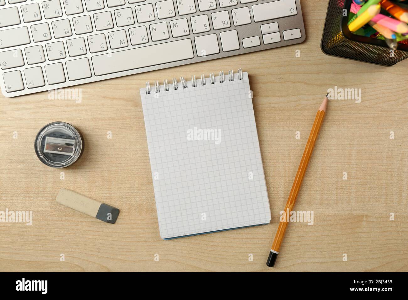White keyboard and notebook on the desk Stock Photo - Alamy