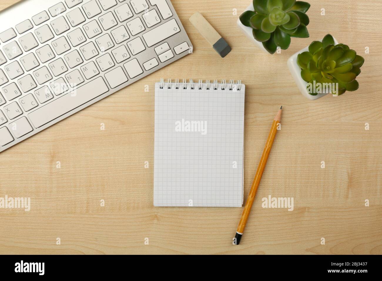 White keyboard and notebook on the desk Stock Photo - Alamy