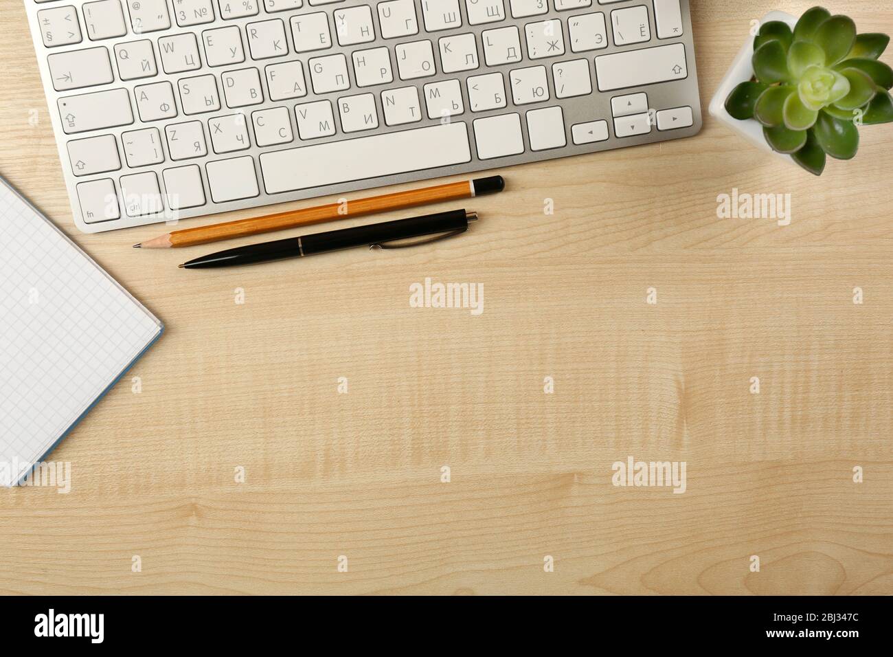 White keyboard and notebook on the desk Stock Photo - Alamy