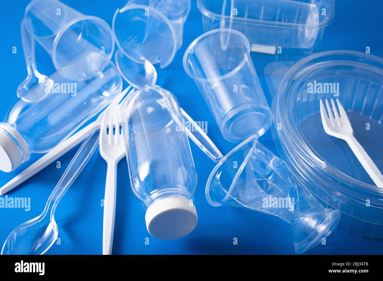 single use plastic bottles, cups, forks, spoons. concept of recycling ...