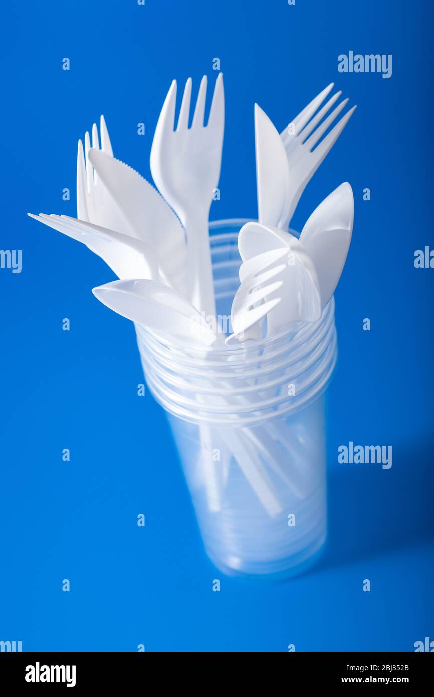 single use plastic cups, forks, spoons. concept of recycling plastic ...