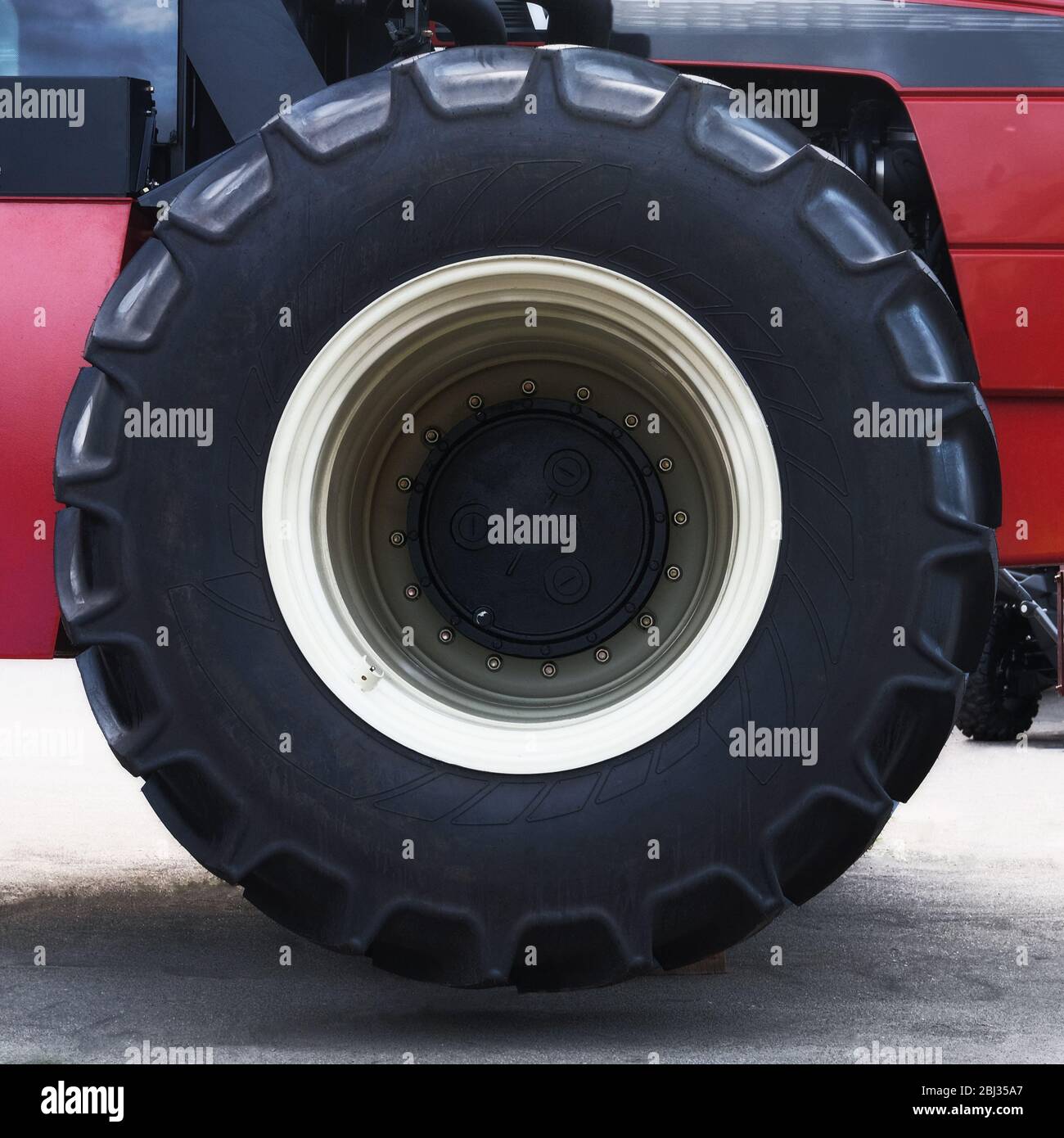 Black tractor wheel, close up. Agronomy, farming, husbandry concept ...