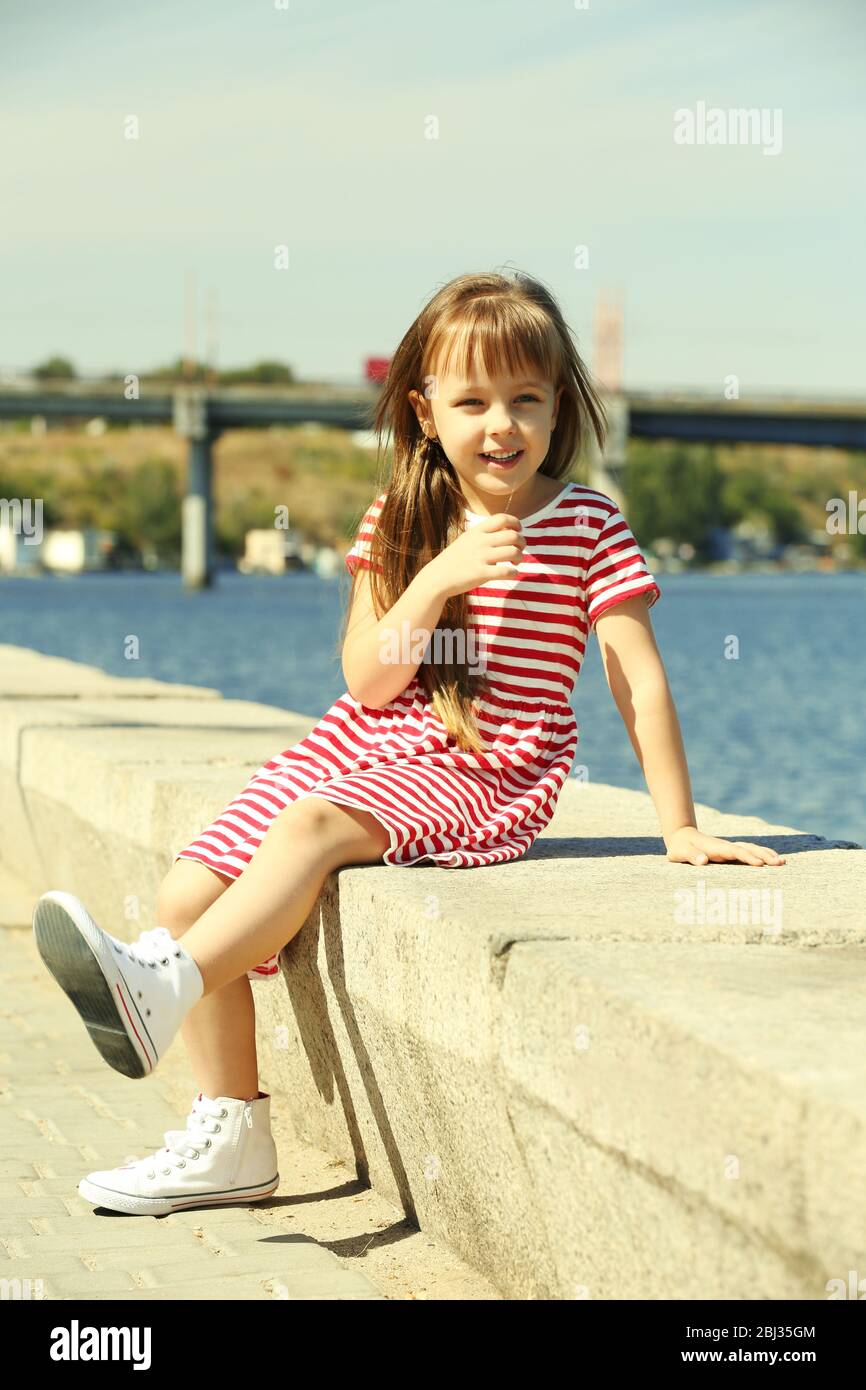 Little girl on the riverside Stock Photo - Alamy