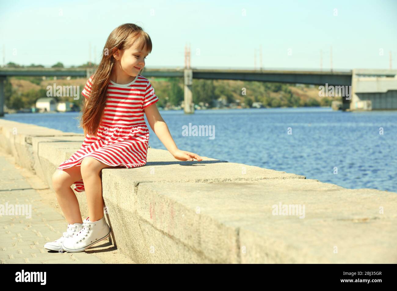 Little girl on the riverside Stock Photo - Alamy