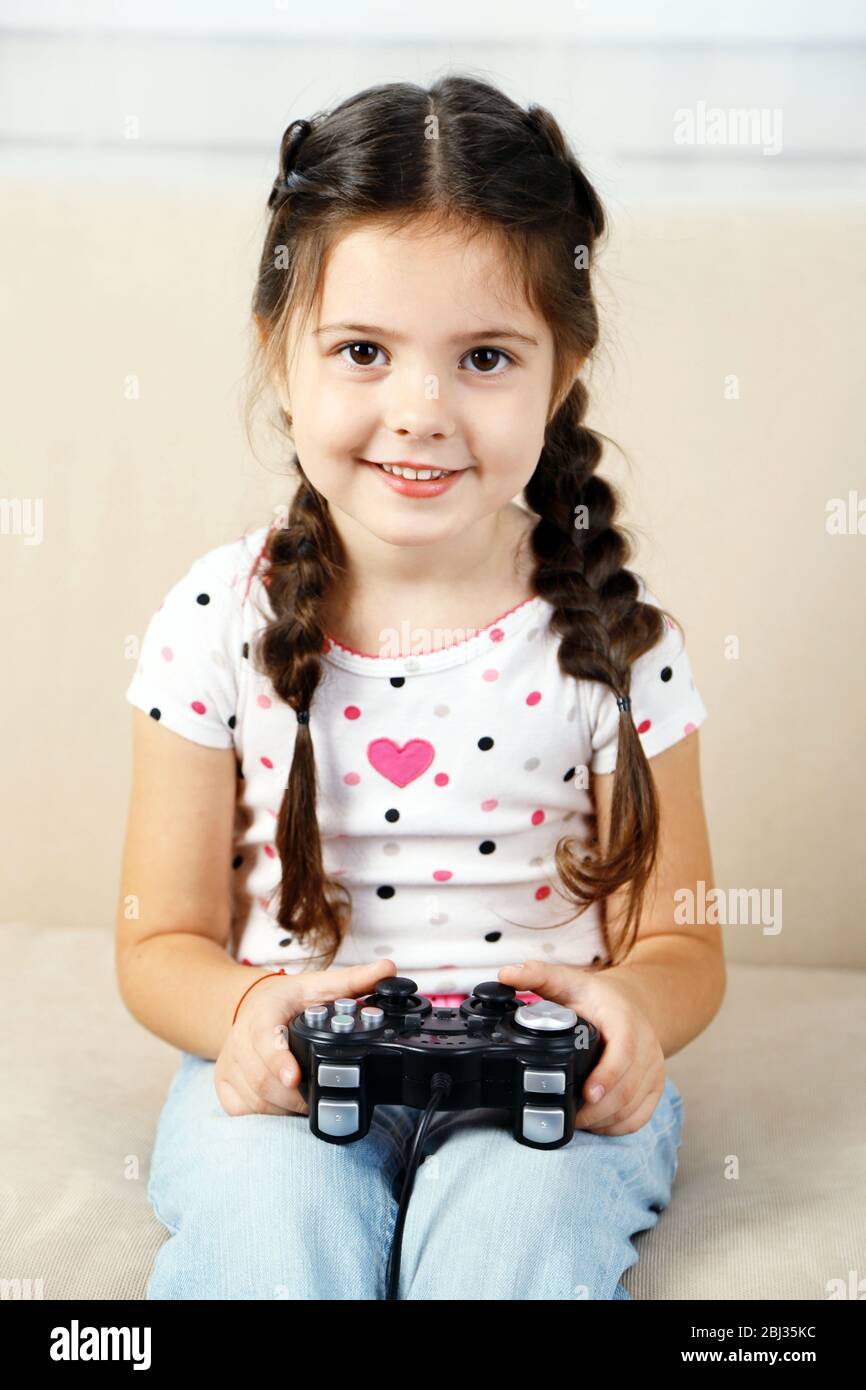 Happy Caucasian girl playing video games holding game controller ...