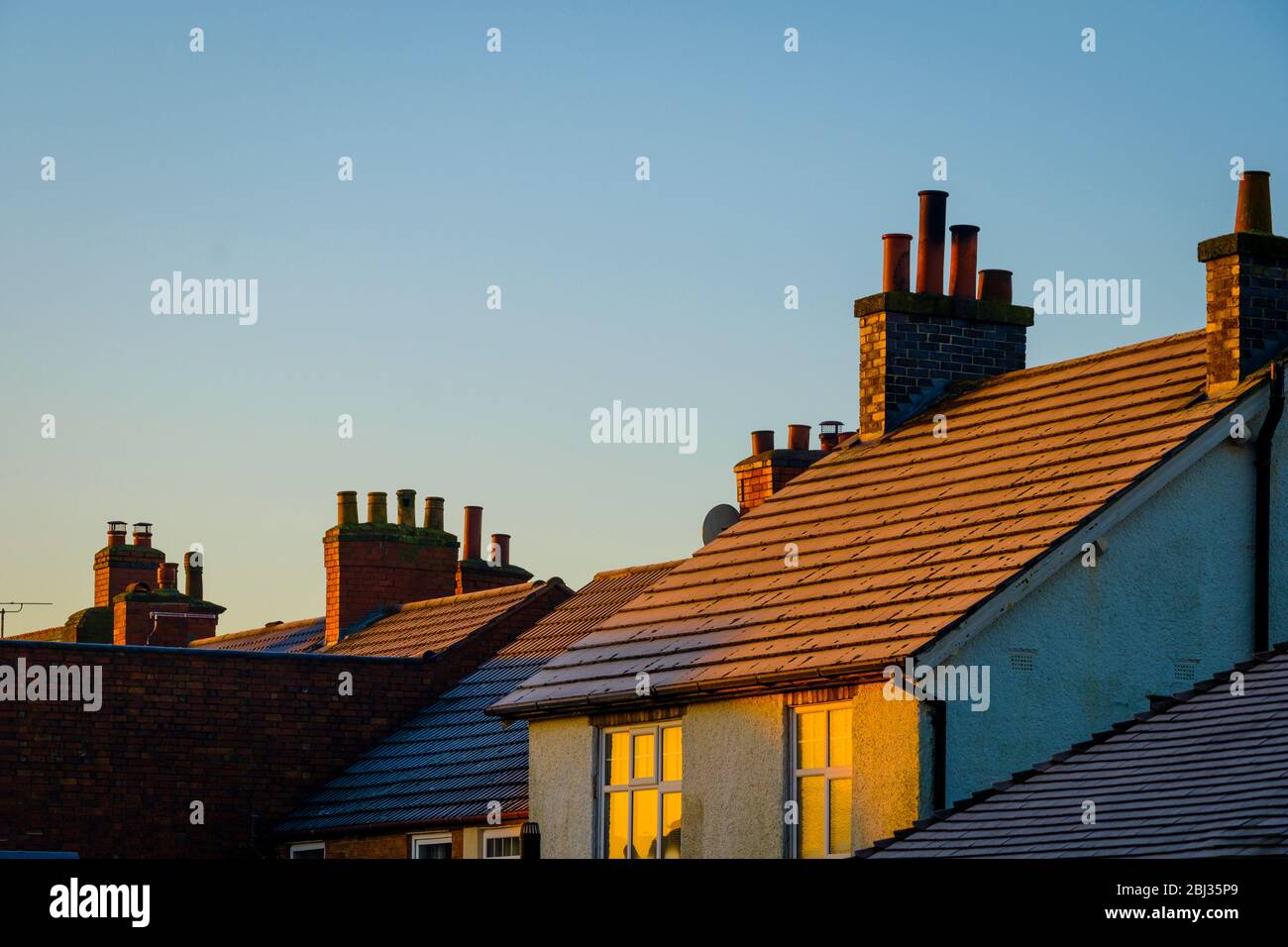 Chimneys and rooftops catch the early morning sun Stock Photo - Alamy