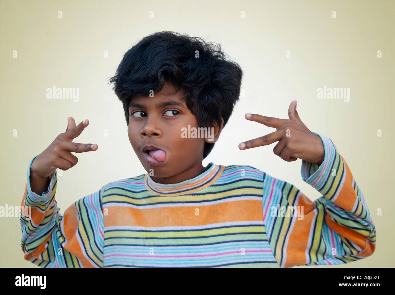 Portrait of a cheerful Rural boy sticking his tongue out Stock Photo ...