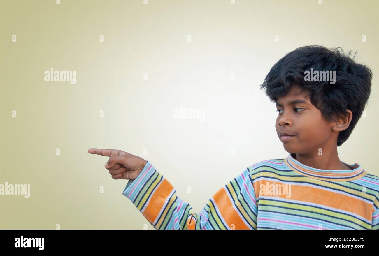 Happy boy Pointing While Looking Away Stock Photo - Alamy