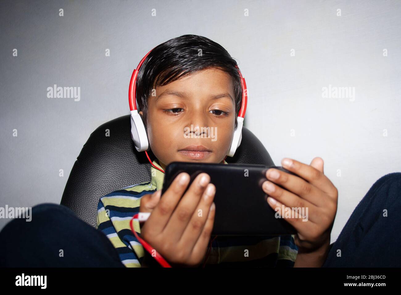 Boy Watching His Mobile Phone With Headset High Resolution Stock ...