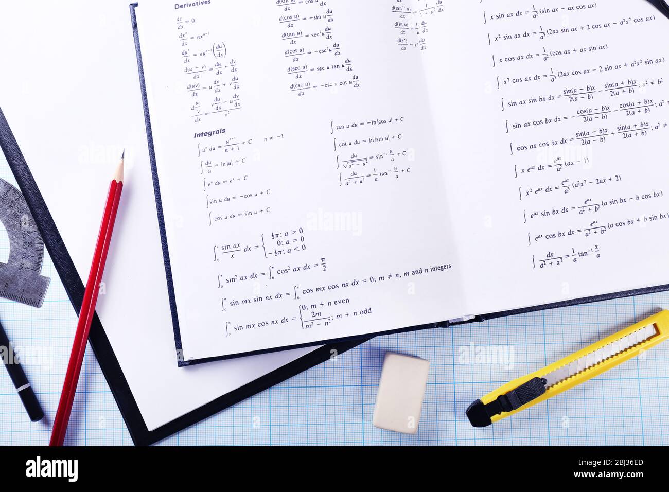 School supplies and textbook on mathematics close up Stock Photo - Alamy