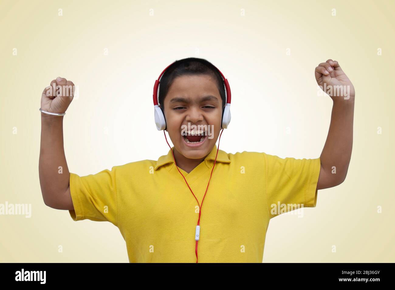 Boy Screaming While Listening Music Against Color Background Stock ...