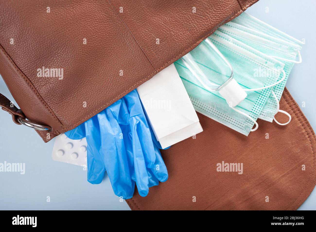 protective medical mask, sanitizer gel and gloves in bag. protective ...