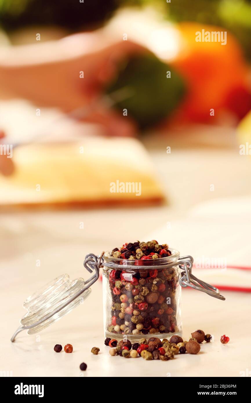 Mix pepper spices in the glass jar on kitchen table Stock Photo - Alamy