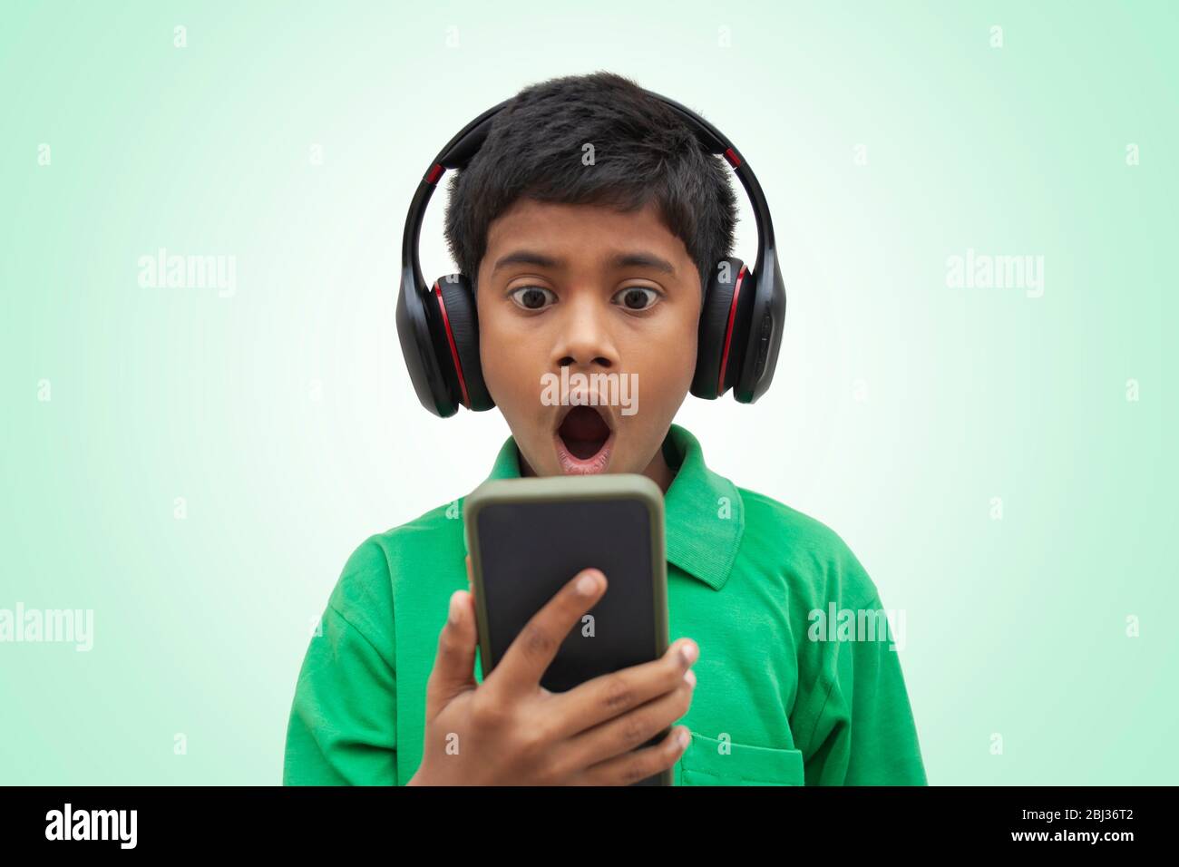 Boy Watching His Mobile Phone With Headset High Resolution Stock ...