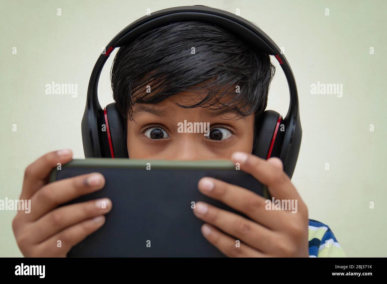 Close- up boy Shocked Face on Smart phone watching movie Stock Photo ...