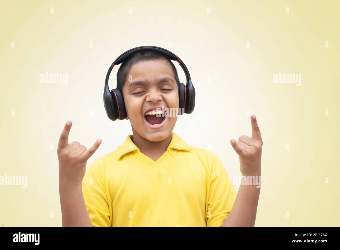 Boy Screaming While Listening Music Against Color Background Stock ...