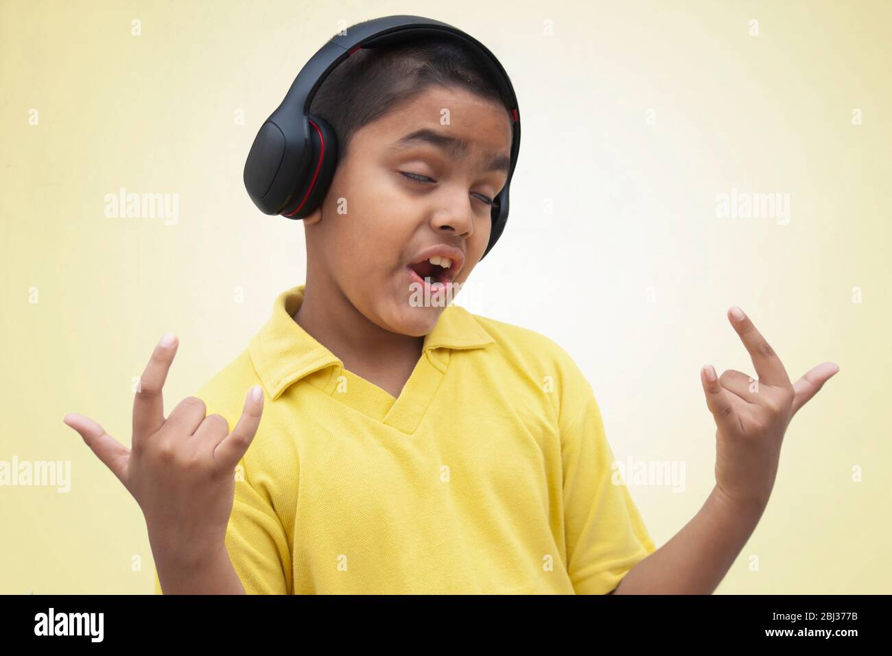 Boy Screaming While Listening Music Against Color Background Stock ...