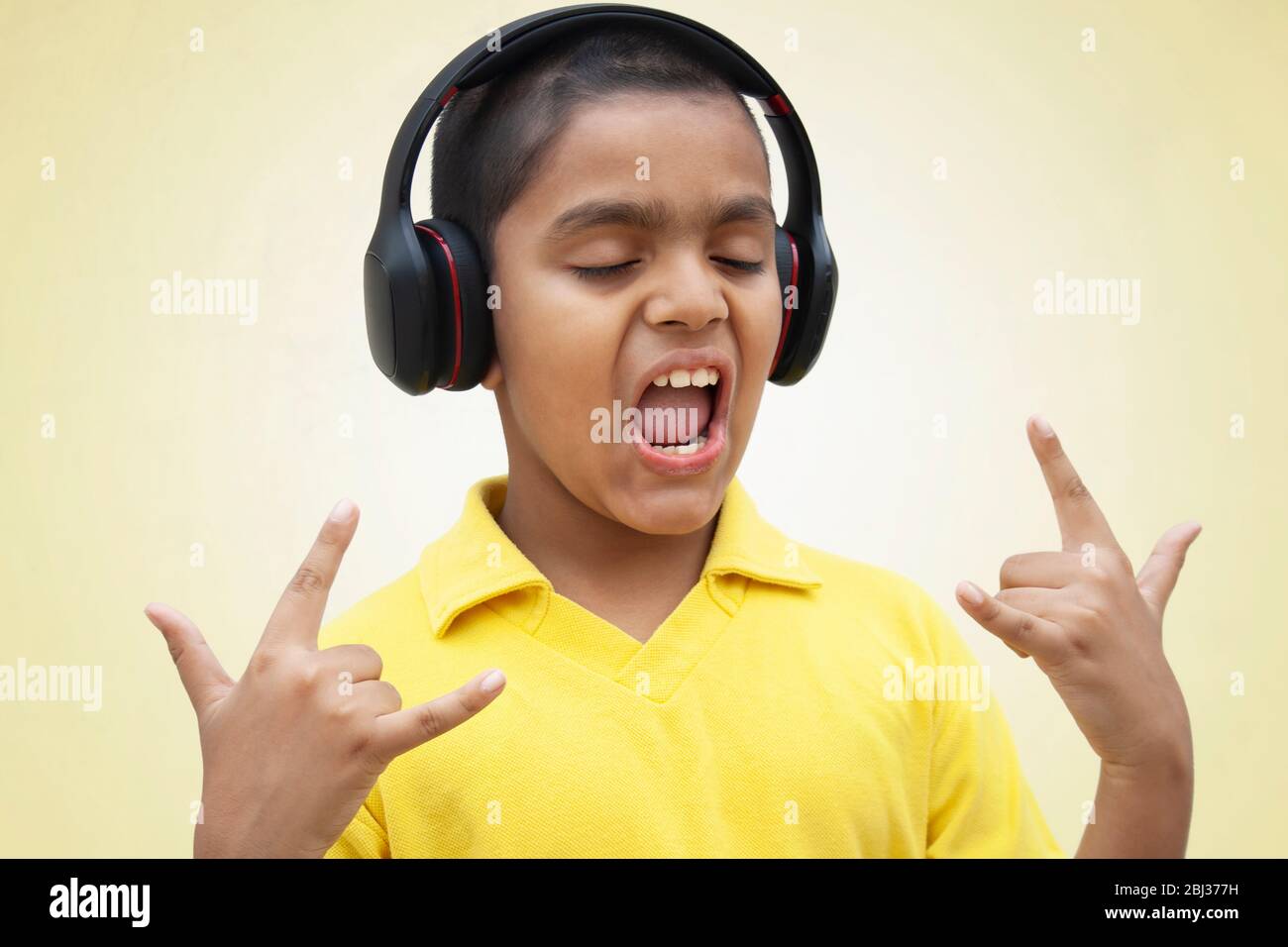Boy Screaming While Listening Music Against Color Background Stock ...