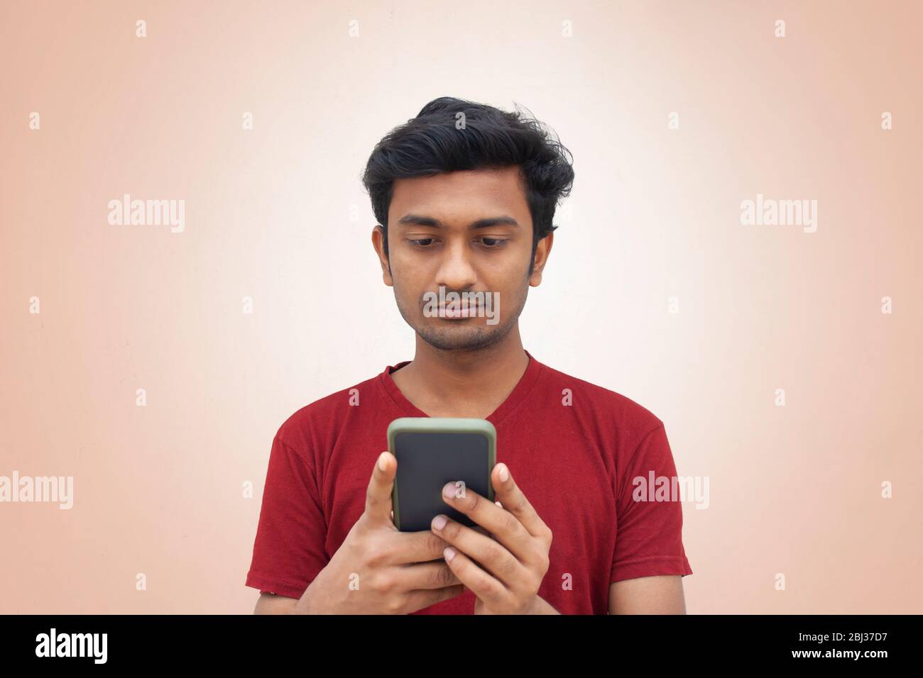 Young boy using mobile phone isolated over Color background Stock Photo ...