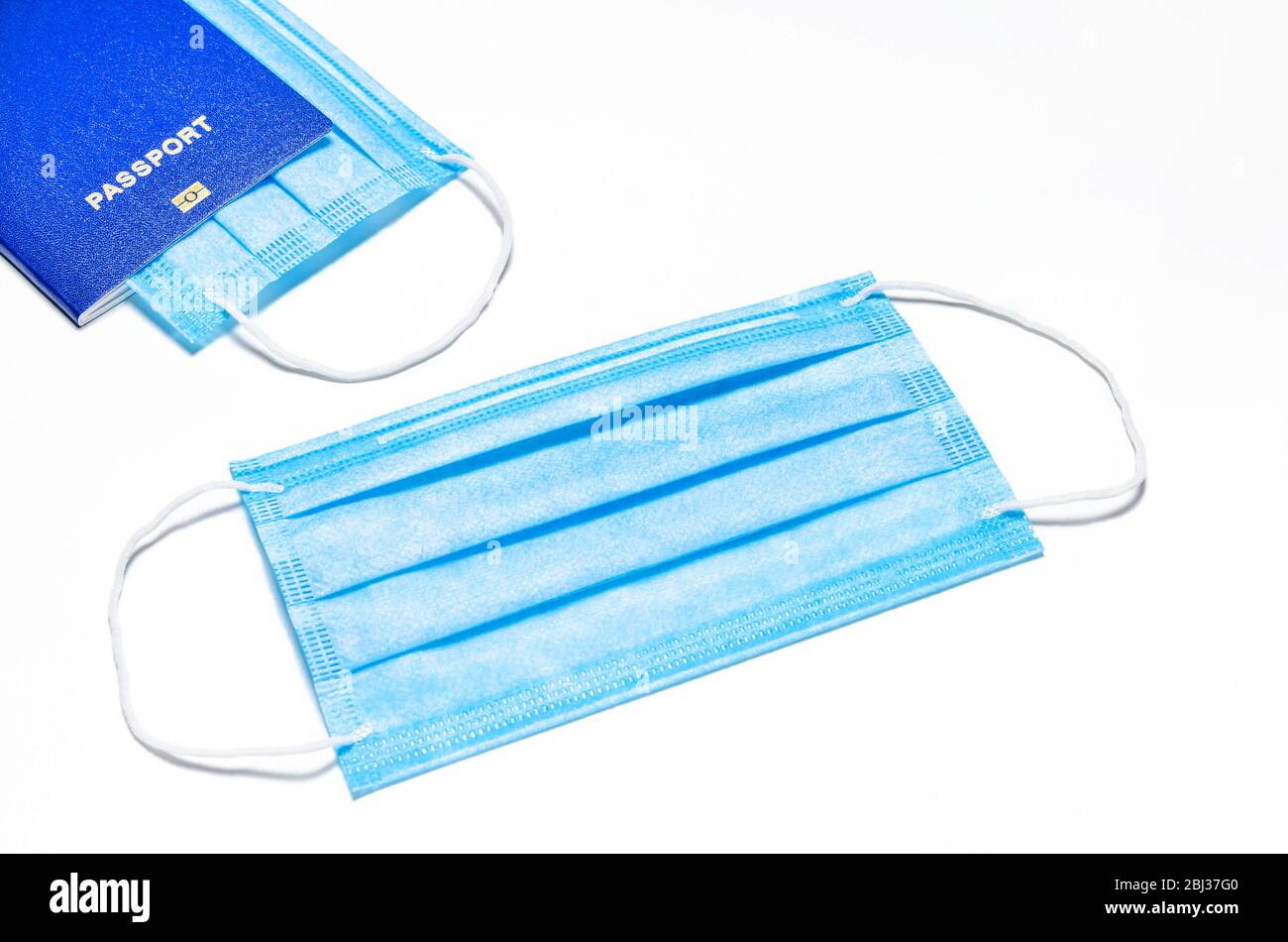 The medical facial mask lies on a white background, in the upper left ...