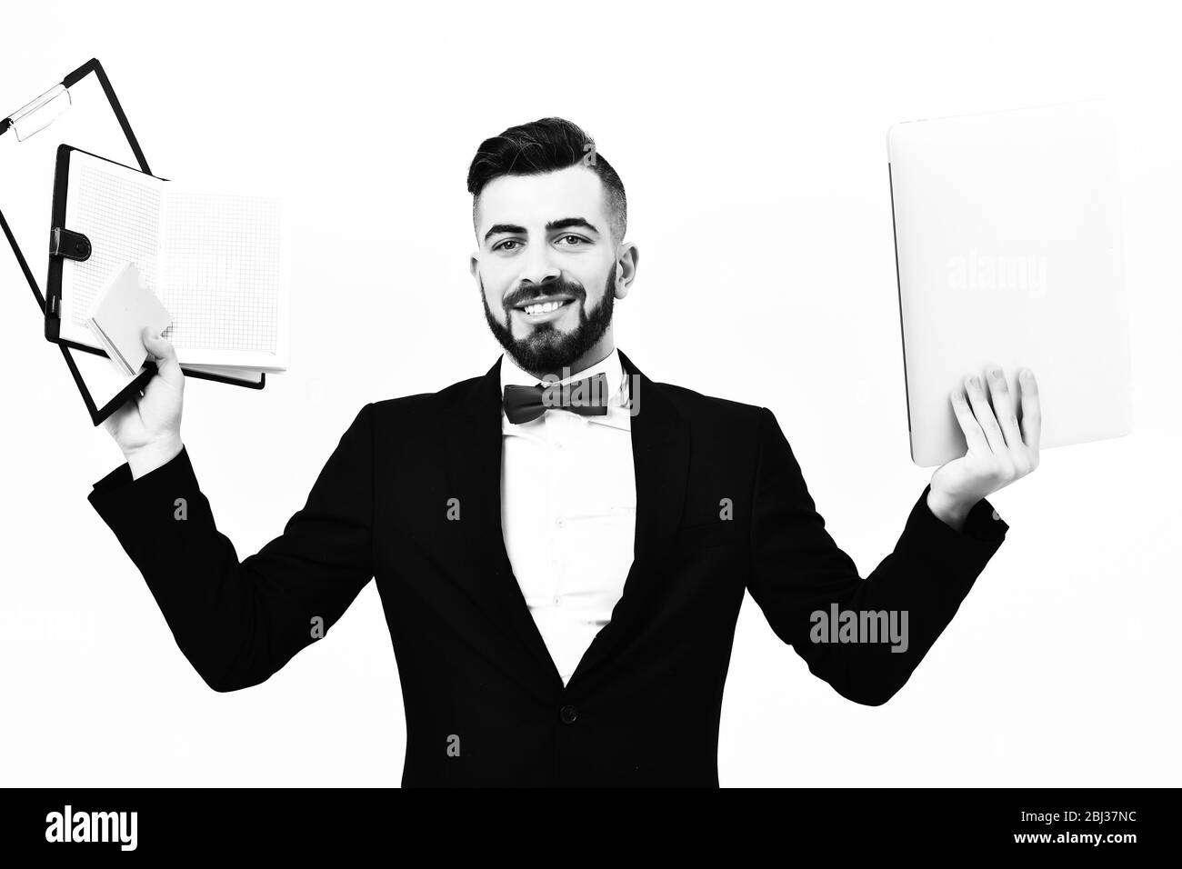 Smiling employer in classic black suit and red bow tie holds open ...