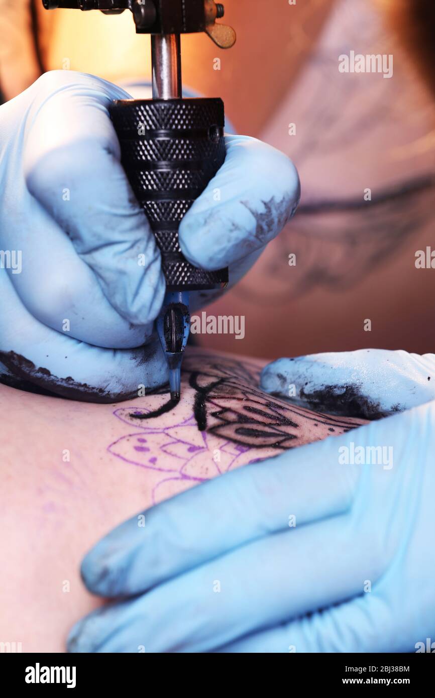Process of making tattoo close-up Stock Photo - Alamy
