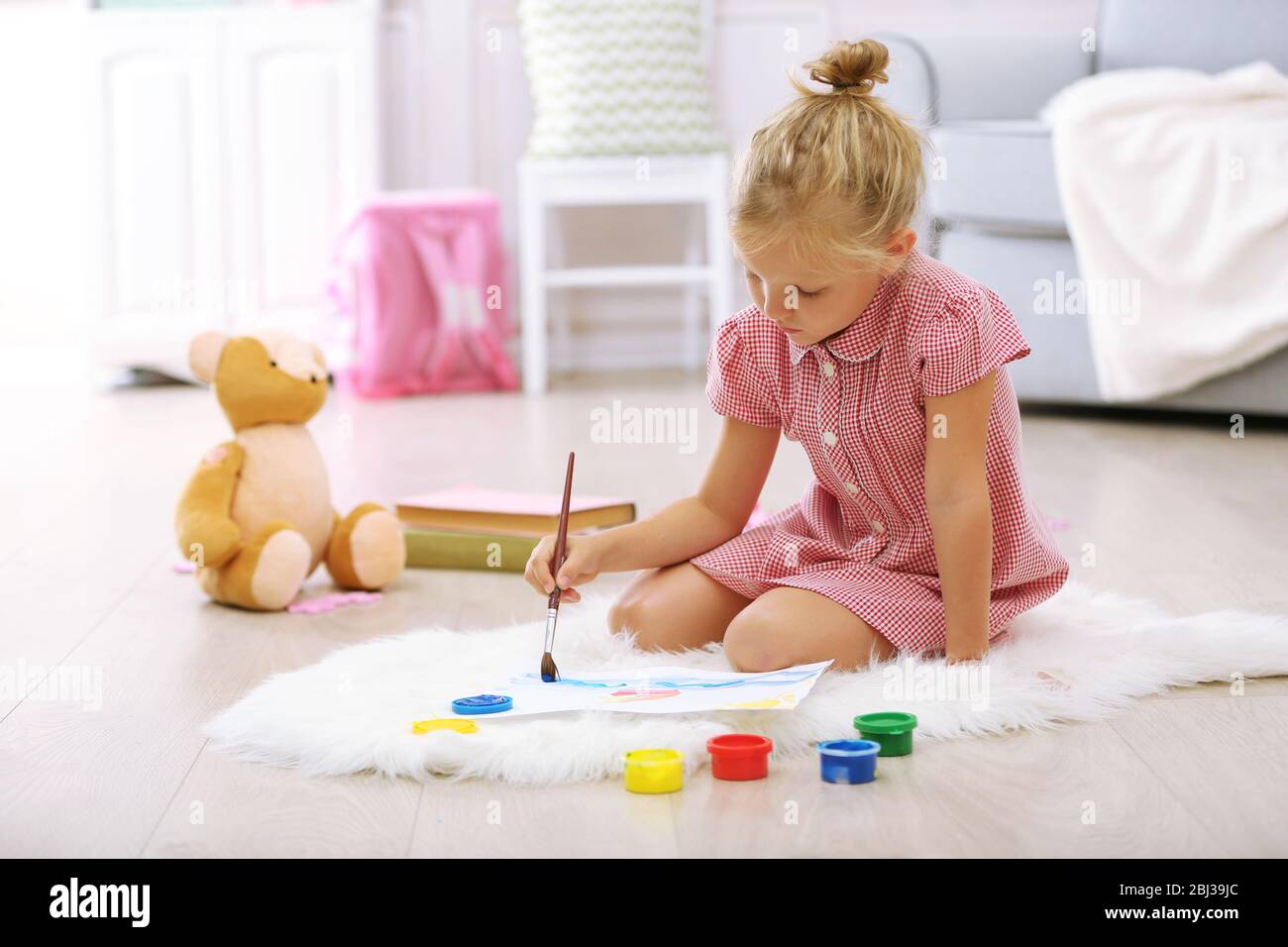 Little girl drawing in the room Stock Photo - Alamy
