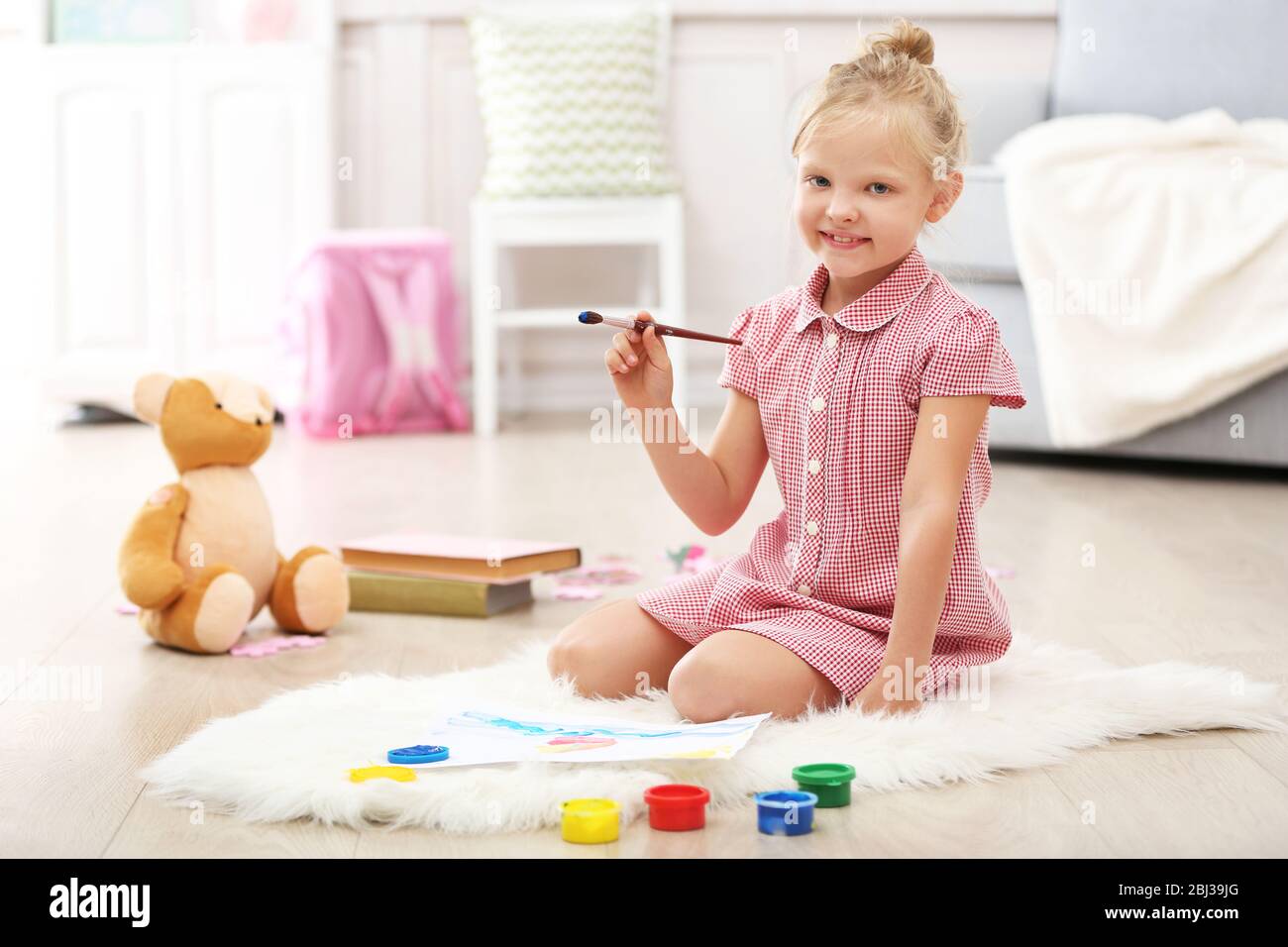 Little girl drawing in the room Stock Photo - Alamy