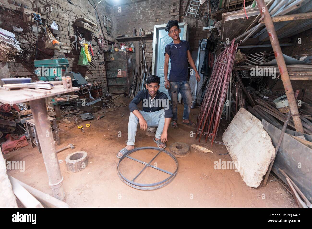 Dhaka / Bangladesh - January 14, 2019: young men inside a messy repair ...