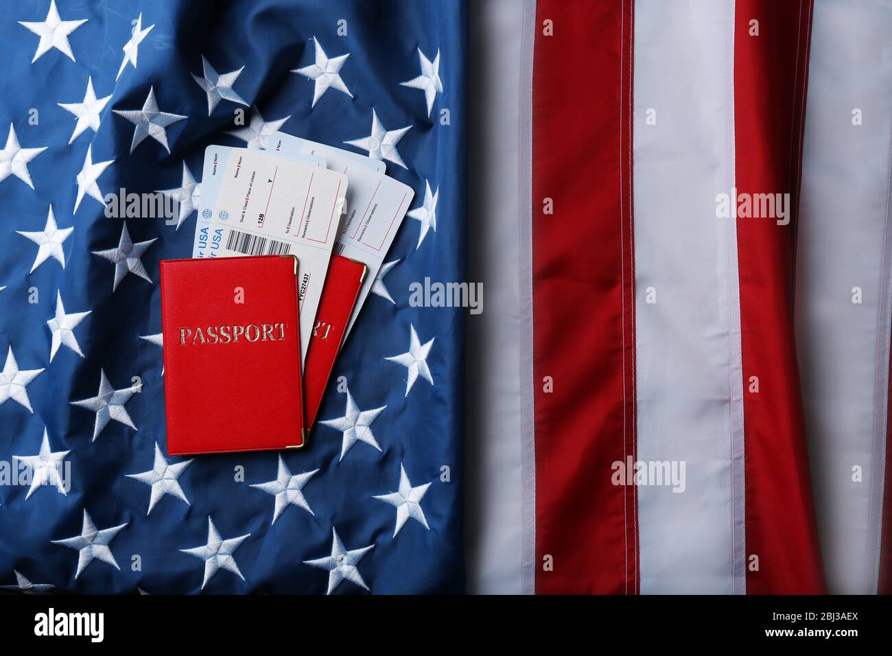 Passports, tickets lying on American Flag background Stock Photo - Alamy