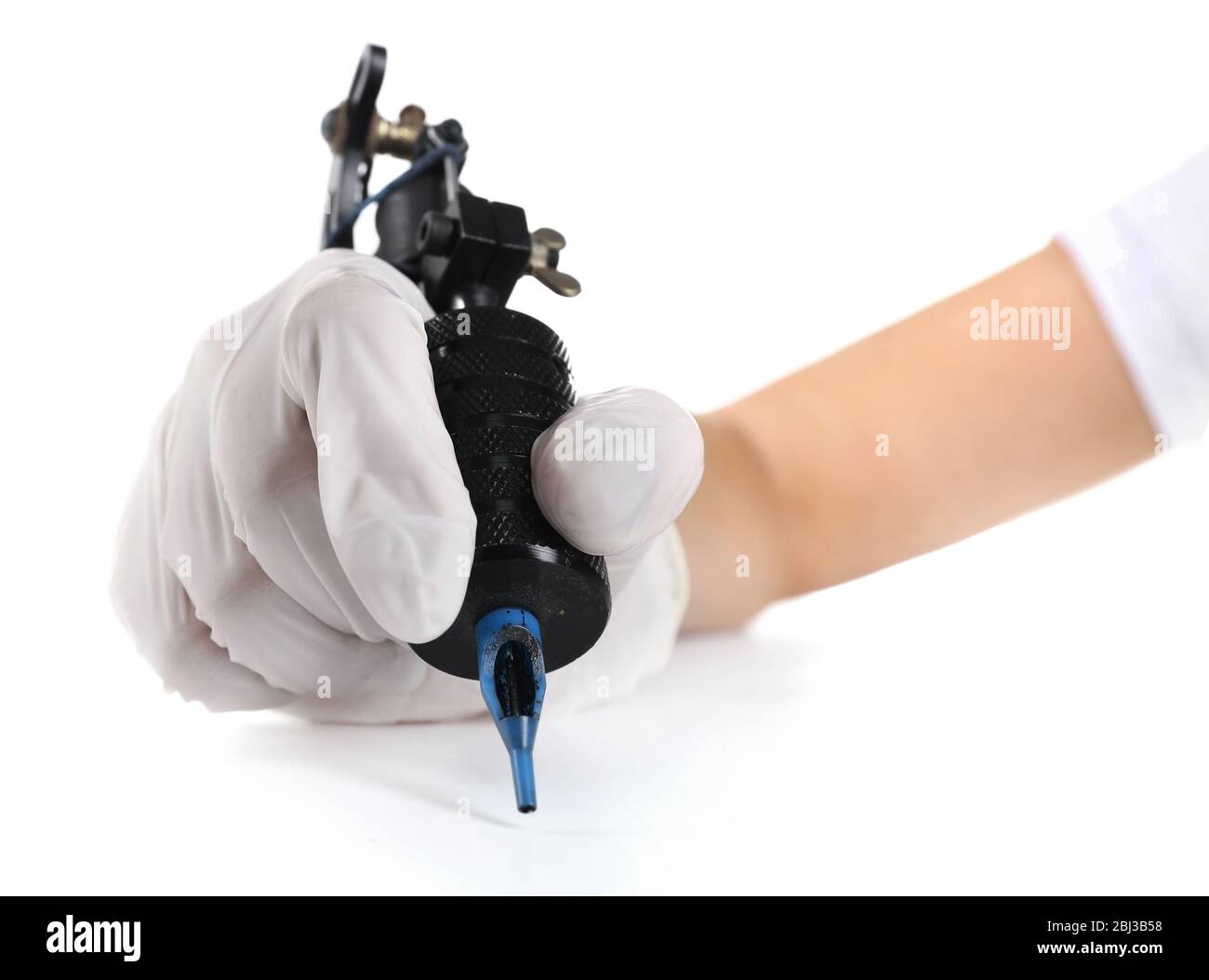 Tattoo machine in hand isolated on white background Stock Photo - Alamy