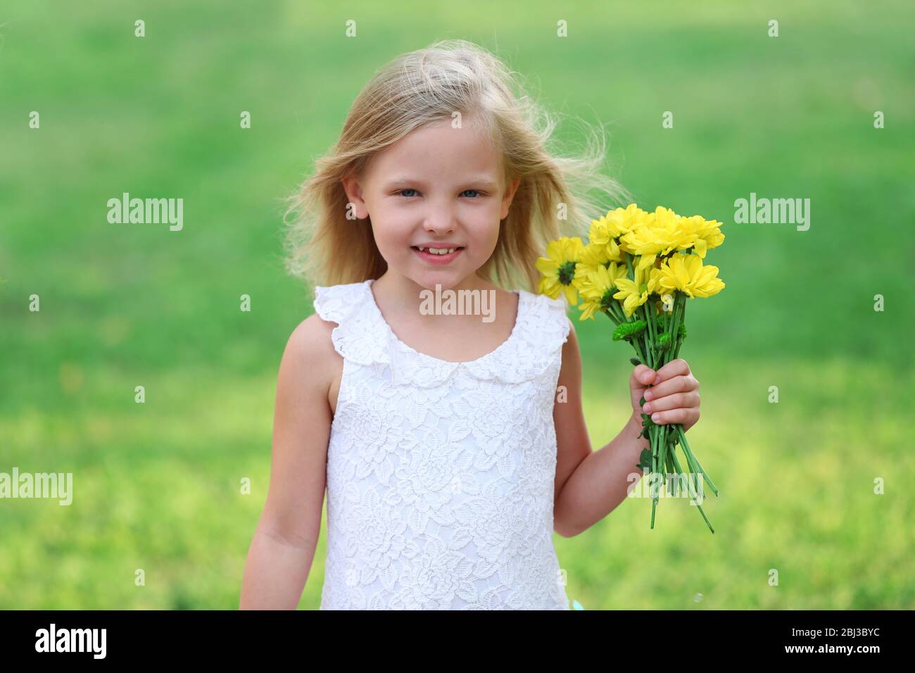 Happy girl walking in park Stock Photo - Alamy
